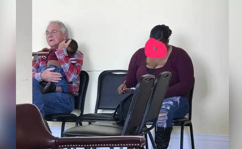 The moving photograph of a man cradling the baby of a mother who needed help