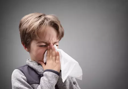 boy sneezing