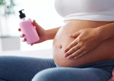 Pregnant Women Applying Cream